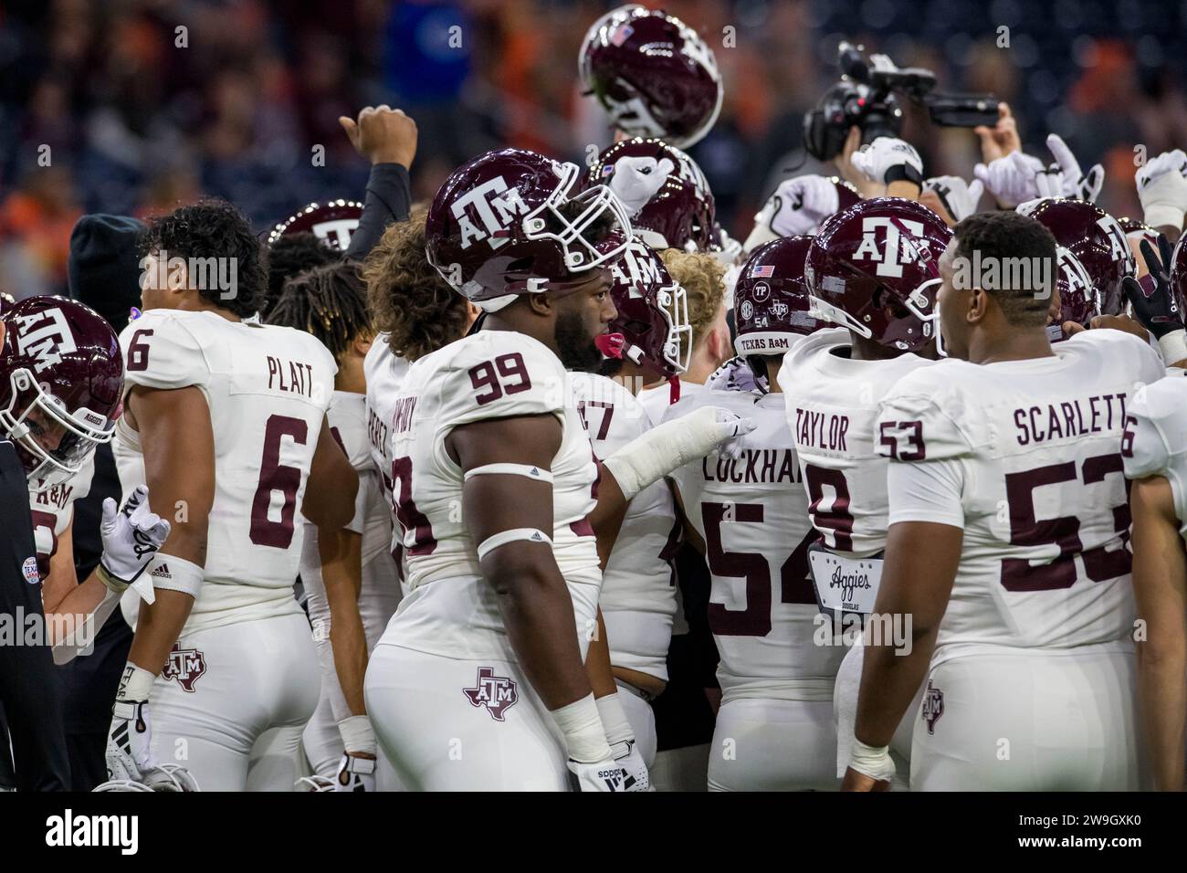 Houston, TX, USA. 27th Dec, 2023. The Texas A&M Aggies huddle up prior ...