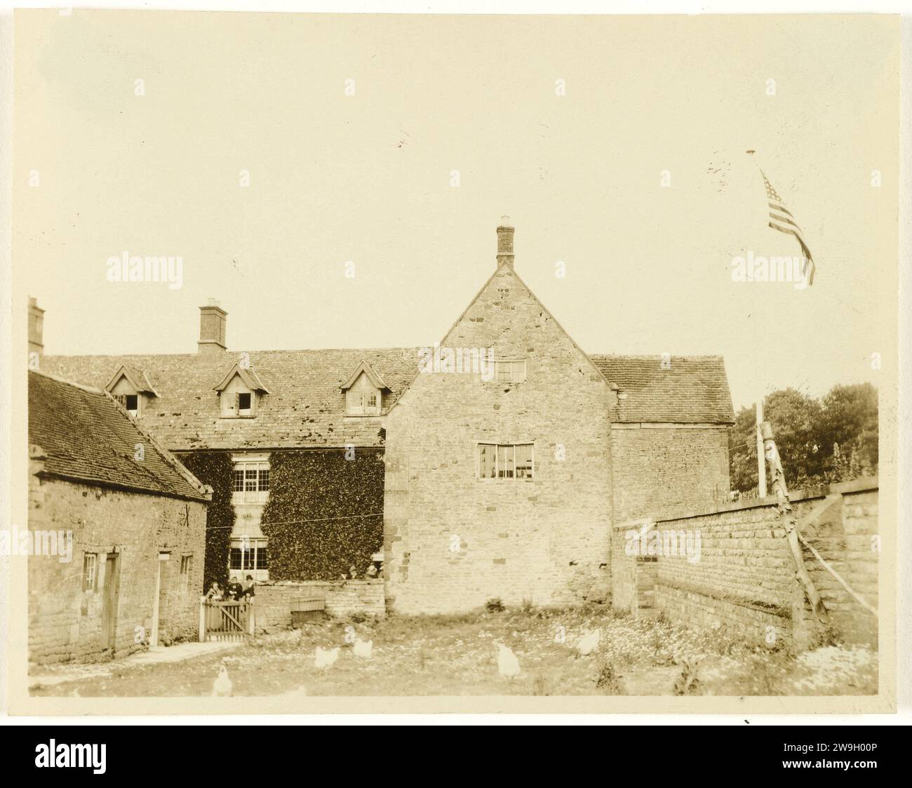 Group of American tourists at a house with an American flag (England ...