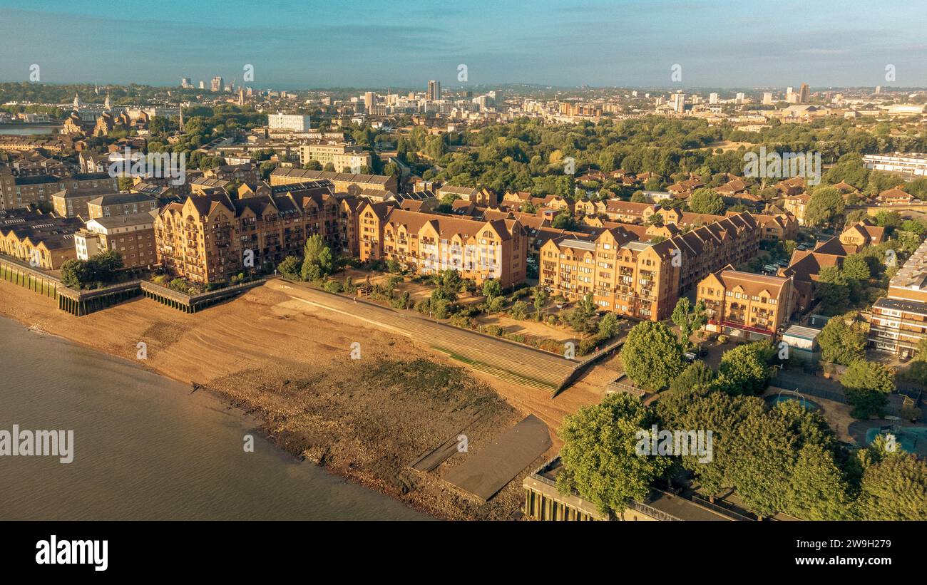 An aerial shot of a coastal cityscape featuring a sandy shoreline and ...