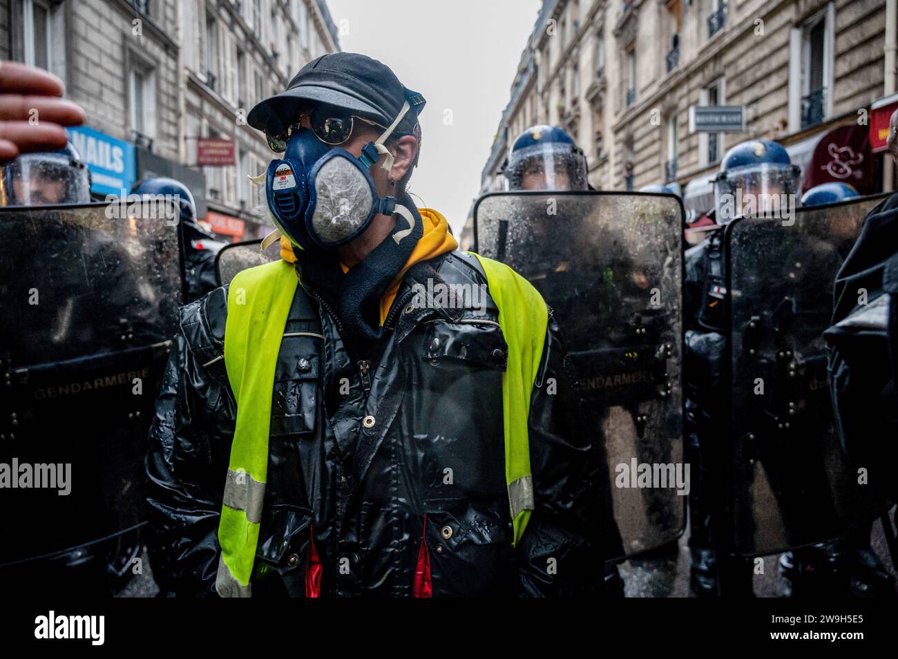 A "yellow vest" anti-government protester is seen with a gas mask with ...