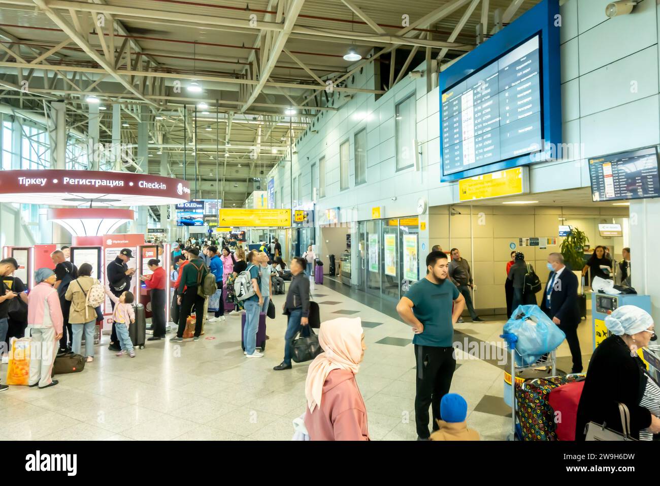 Passengers in the departure terminal in Almaty airport Kazakhstan Stock ...