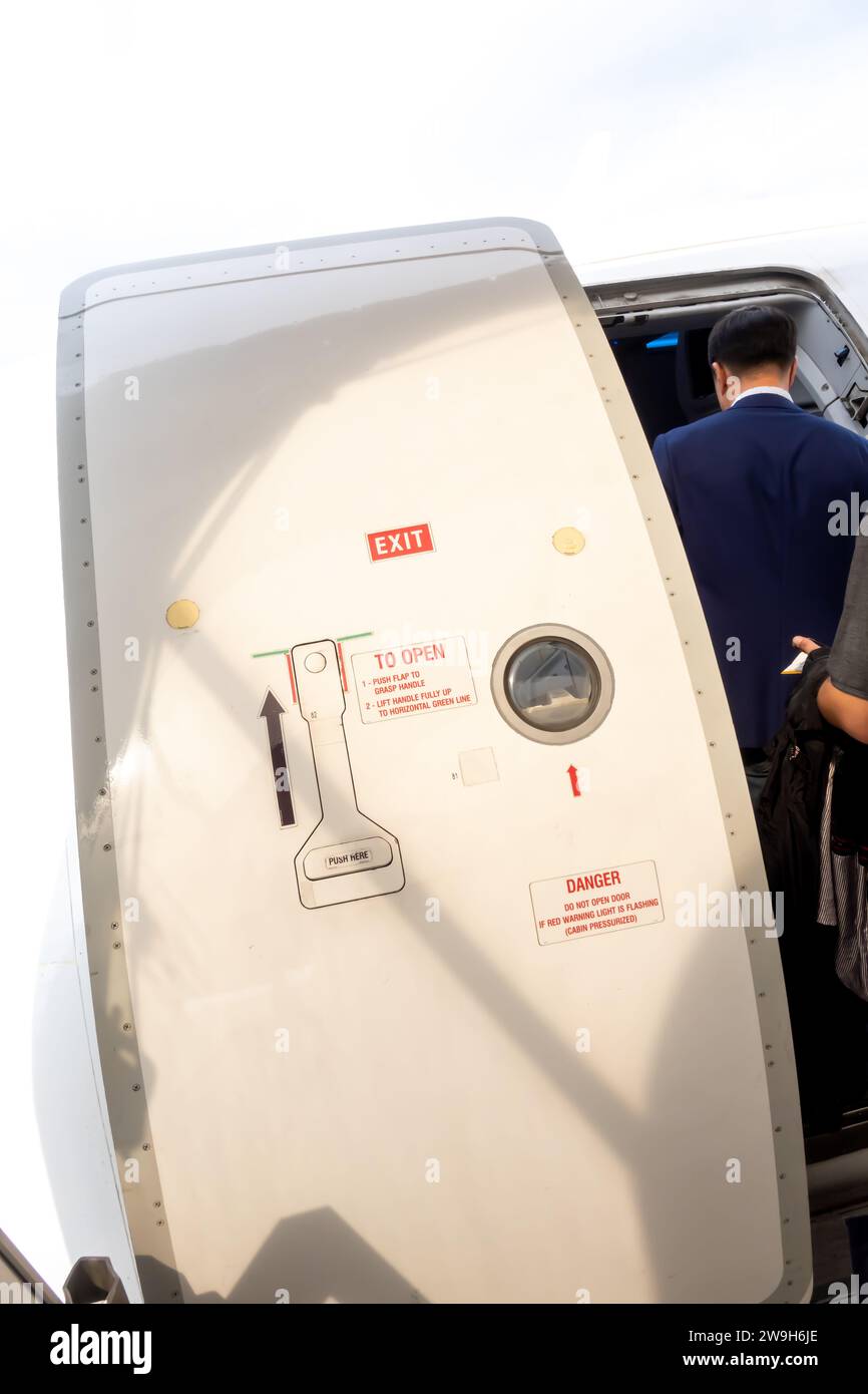 View of a door of an aircarft Airbus with signs and directions to use ...