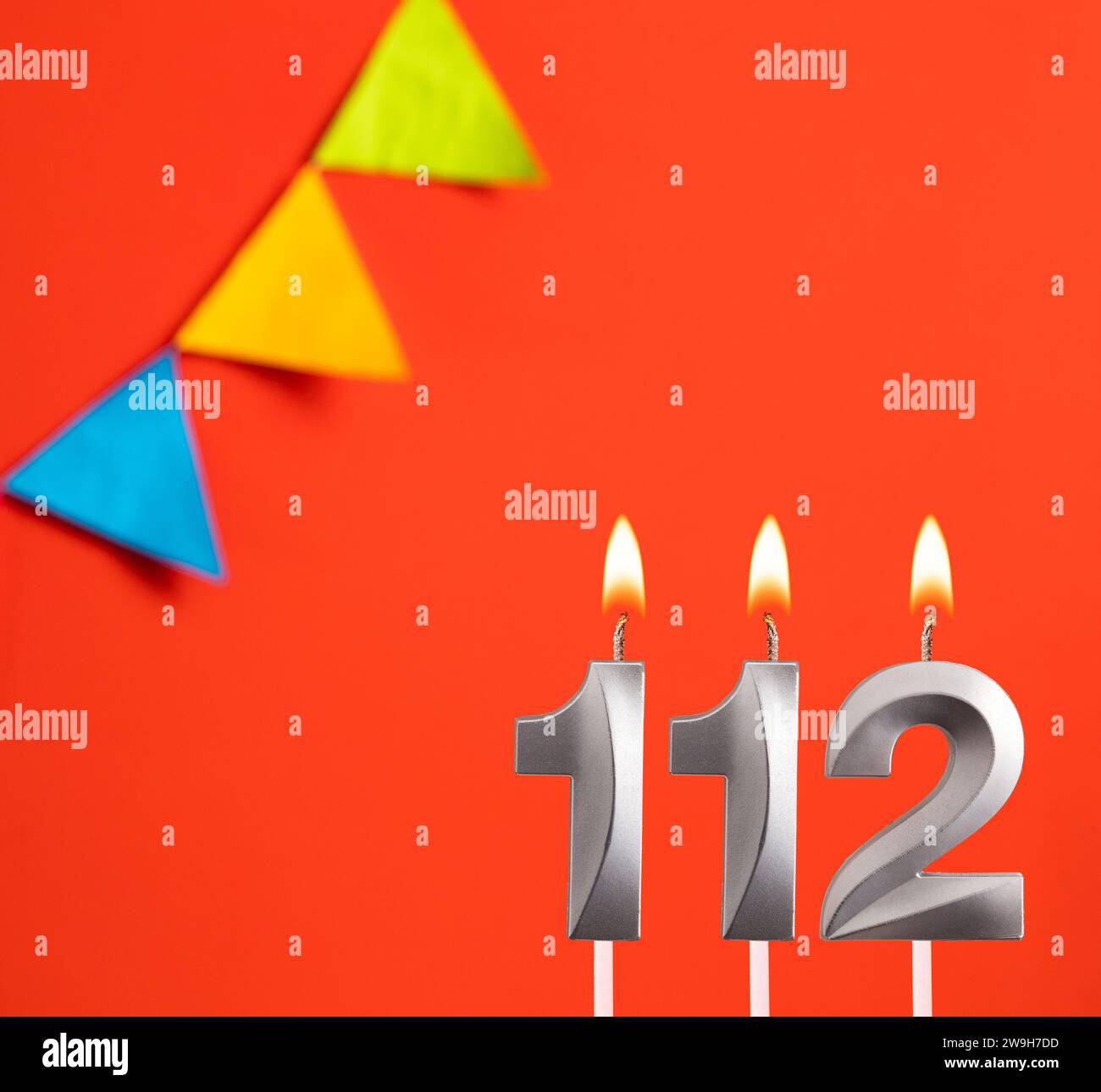 Birthday card - Number 112 candle in orange background Stock Photo - Alamy