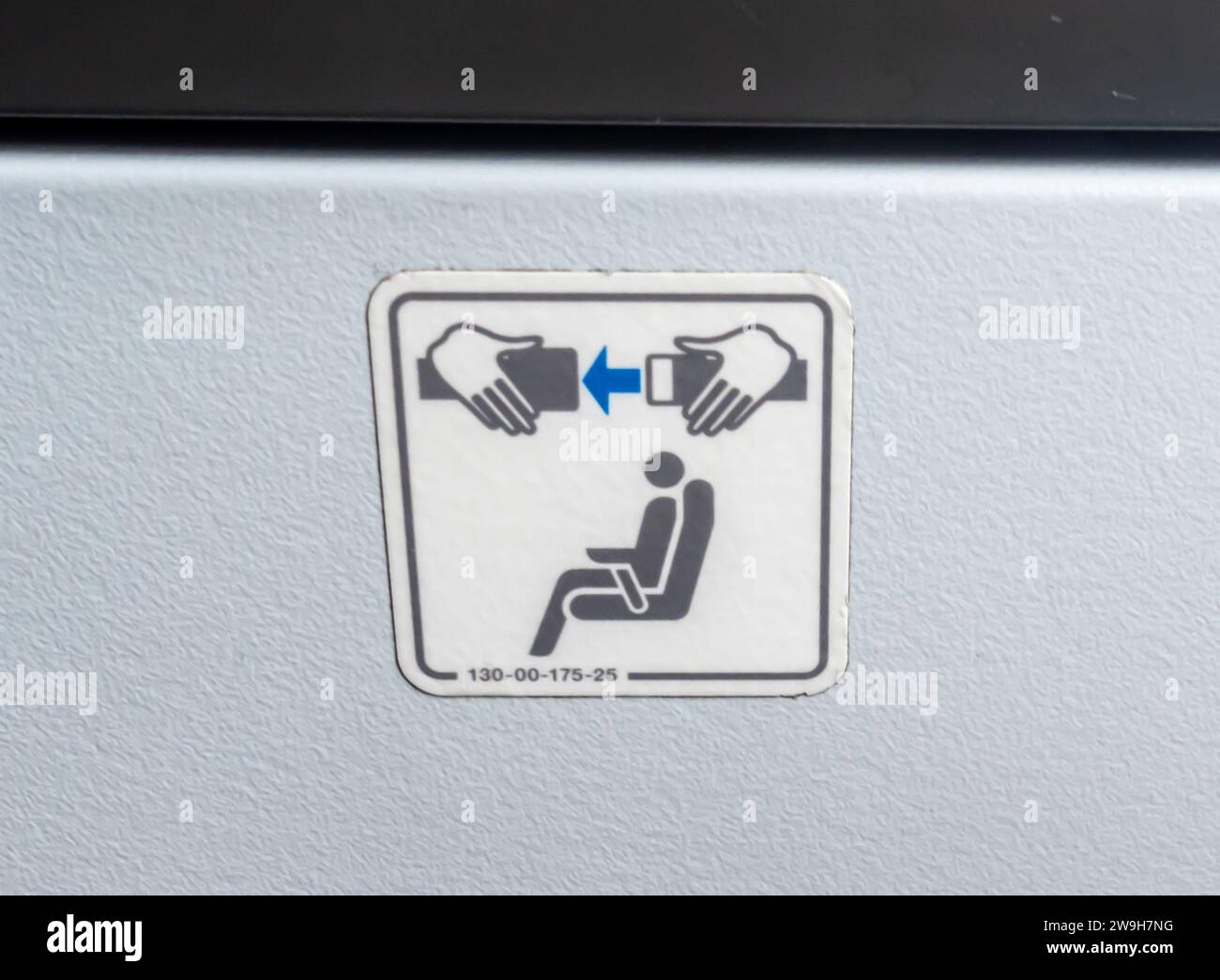 Airplane seat graphics warning to fasten a seat belt in an aircraft ...