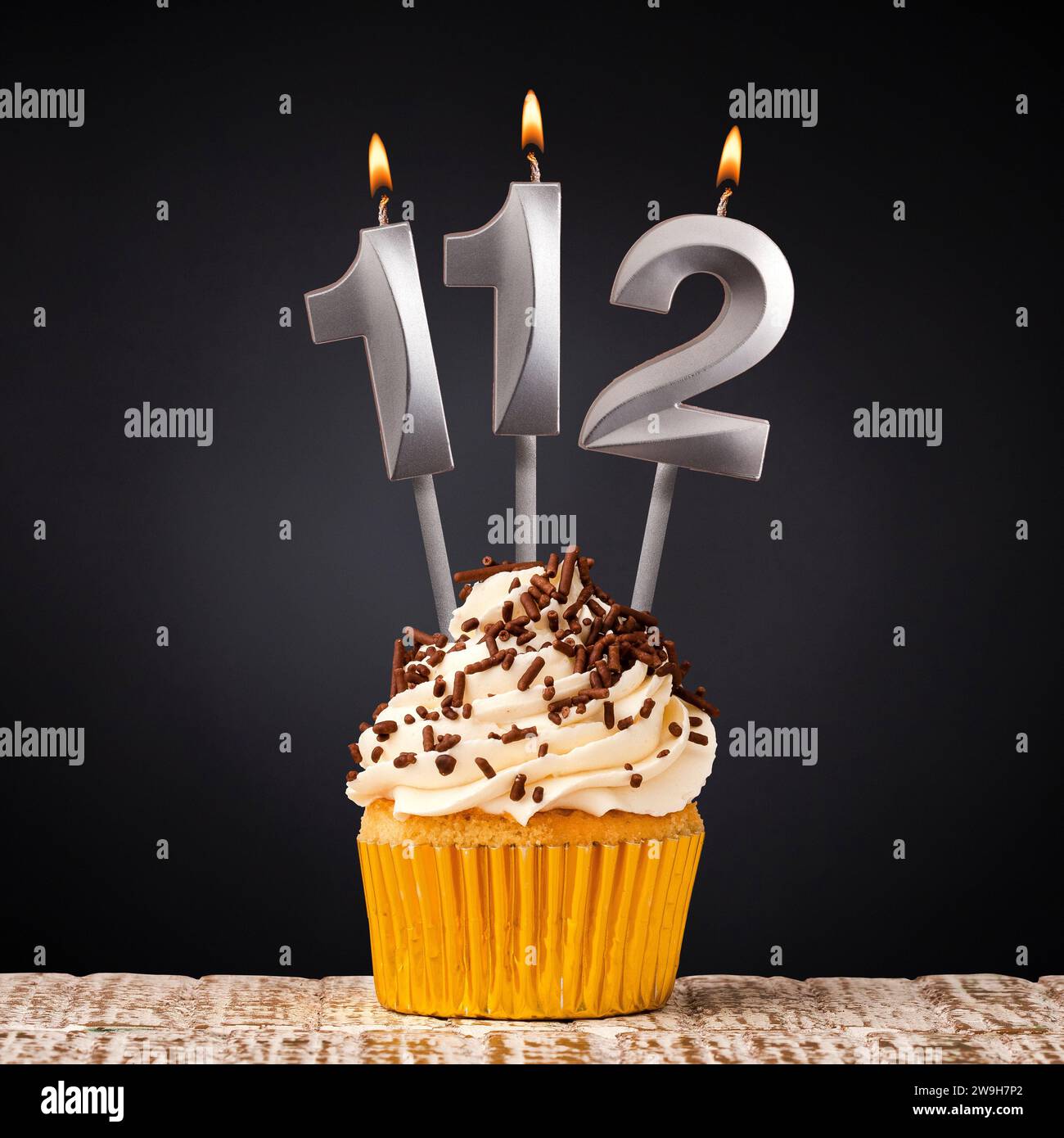 birthday cupcake with number 112 candle - Celebration on dark ...