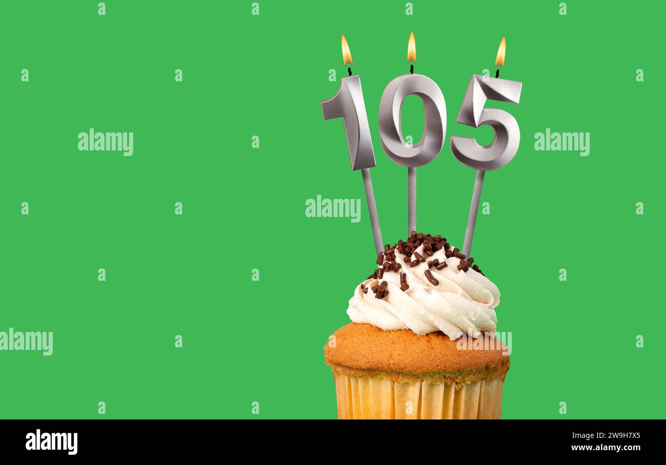 Birthday with number 105 candle and cupcake - Anniversary card on green ...