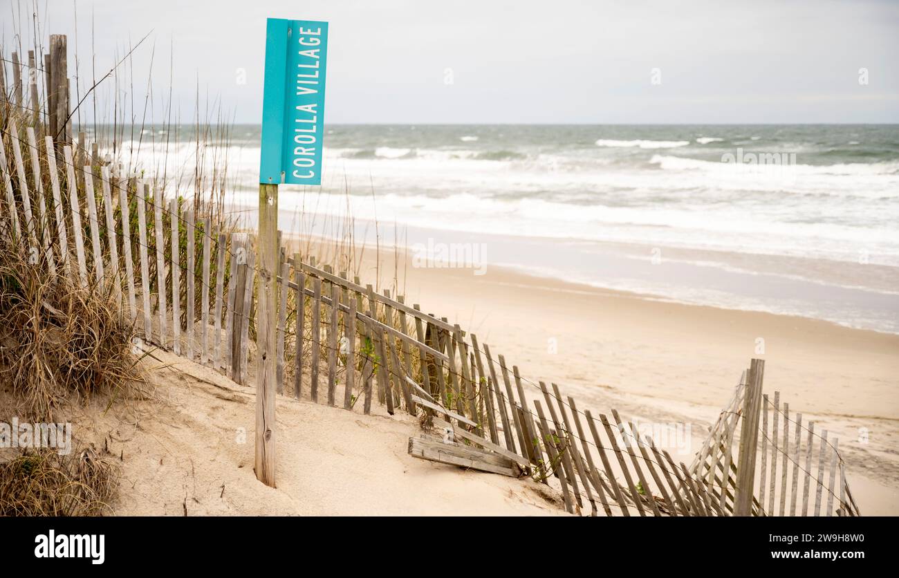 In this wintry Outer Banks beach scene, a broken gate and a weathered ...