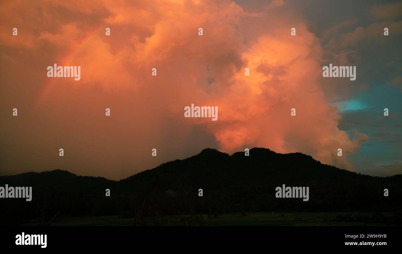 Super sunset sky with mountain silhouettes and decorated with naturally ...