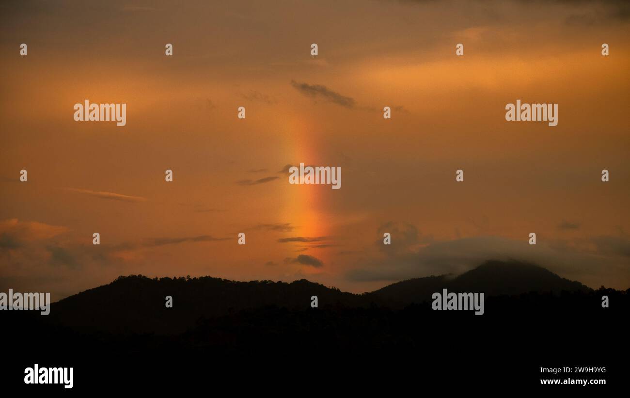 Super sunset sky with mountain silhouettes and decorated with naturally ...