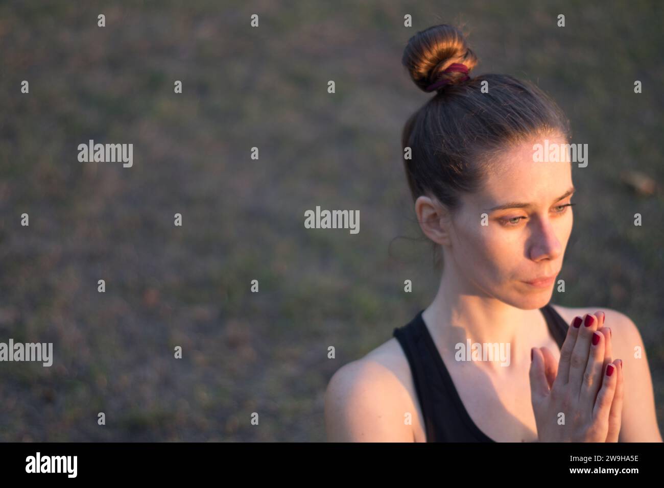 A young White woman in yoga eagle arms stance Stock Photo - Alamy
