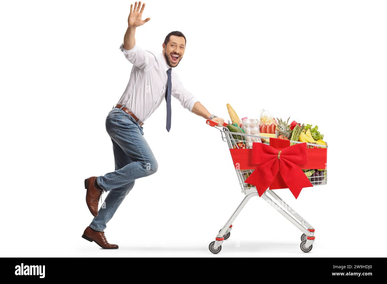 Man running with food in a shopping cart and waving at camera isolated ...