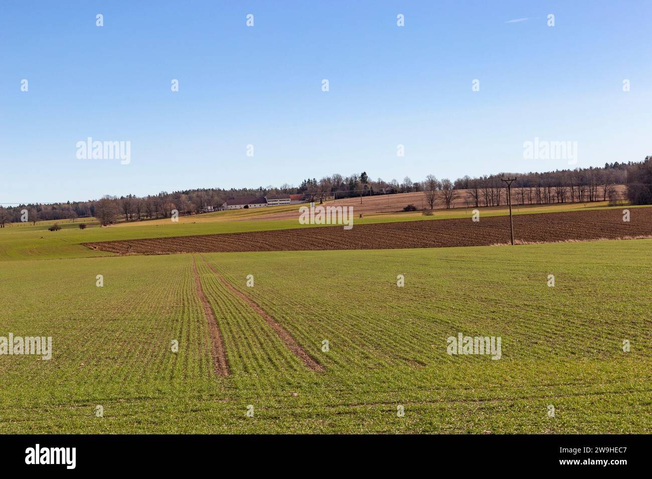 South Bohemian lands with farm, fields and forests. Early springtime ...