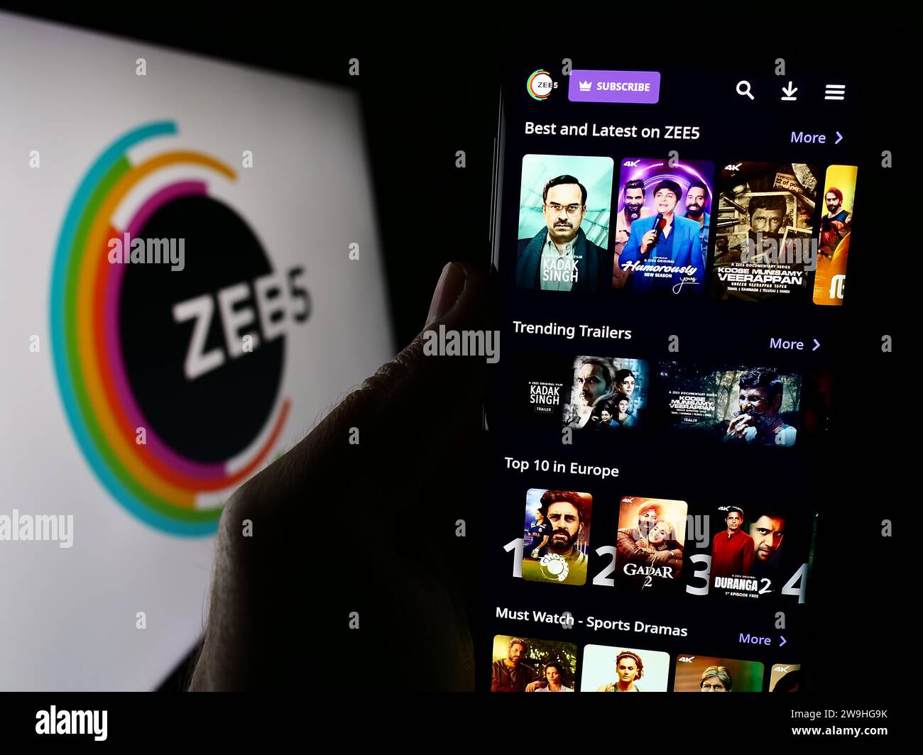 Person holding cellphone with webpage of Indian video streaming ...