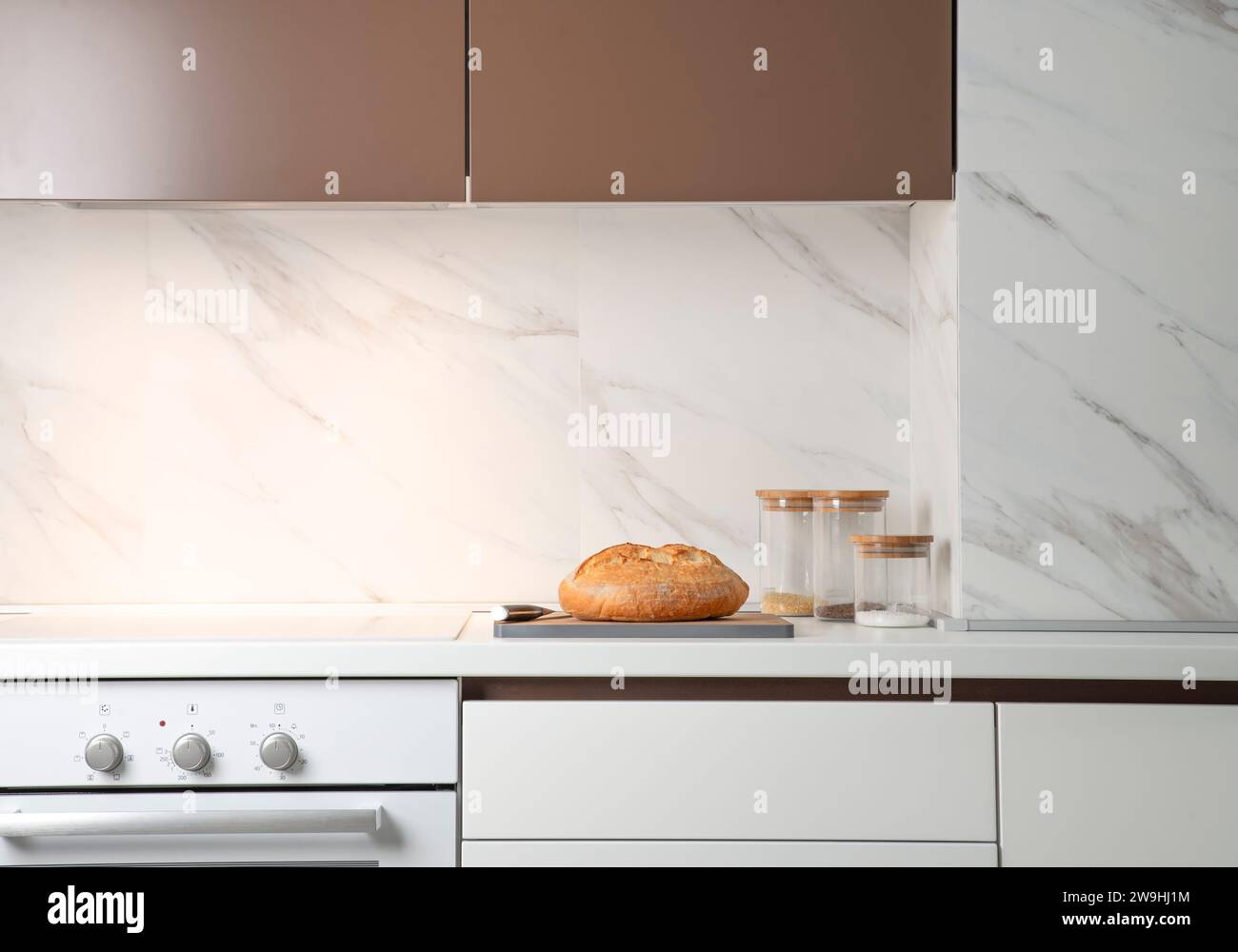 White kitchen interior. On a countertop lies a loaf of bread ...