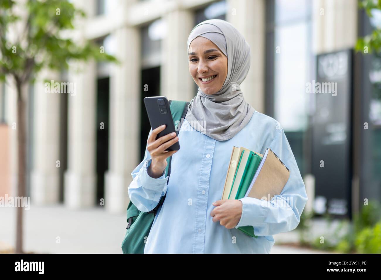 Young muslim woman in hijab walking outside university campus, female ...