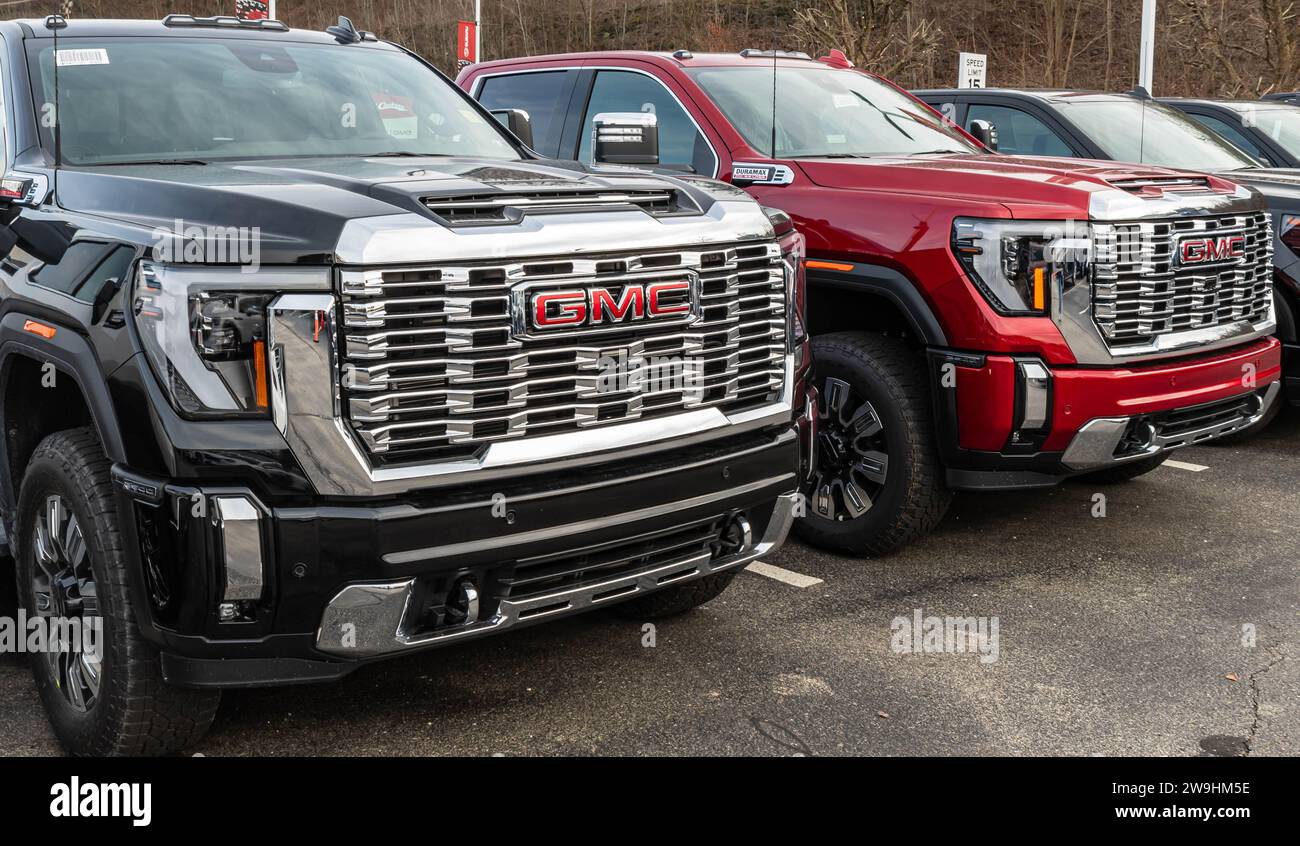 A line of new GMC four door pickup trucks for sale at a dealership in ...