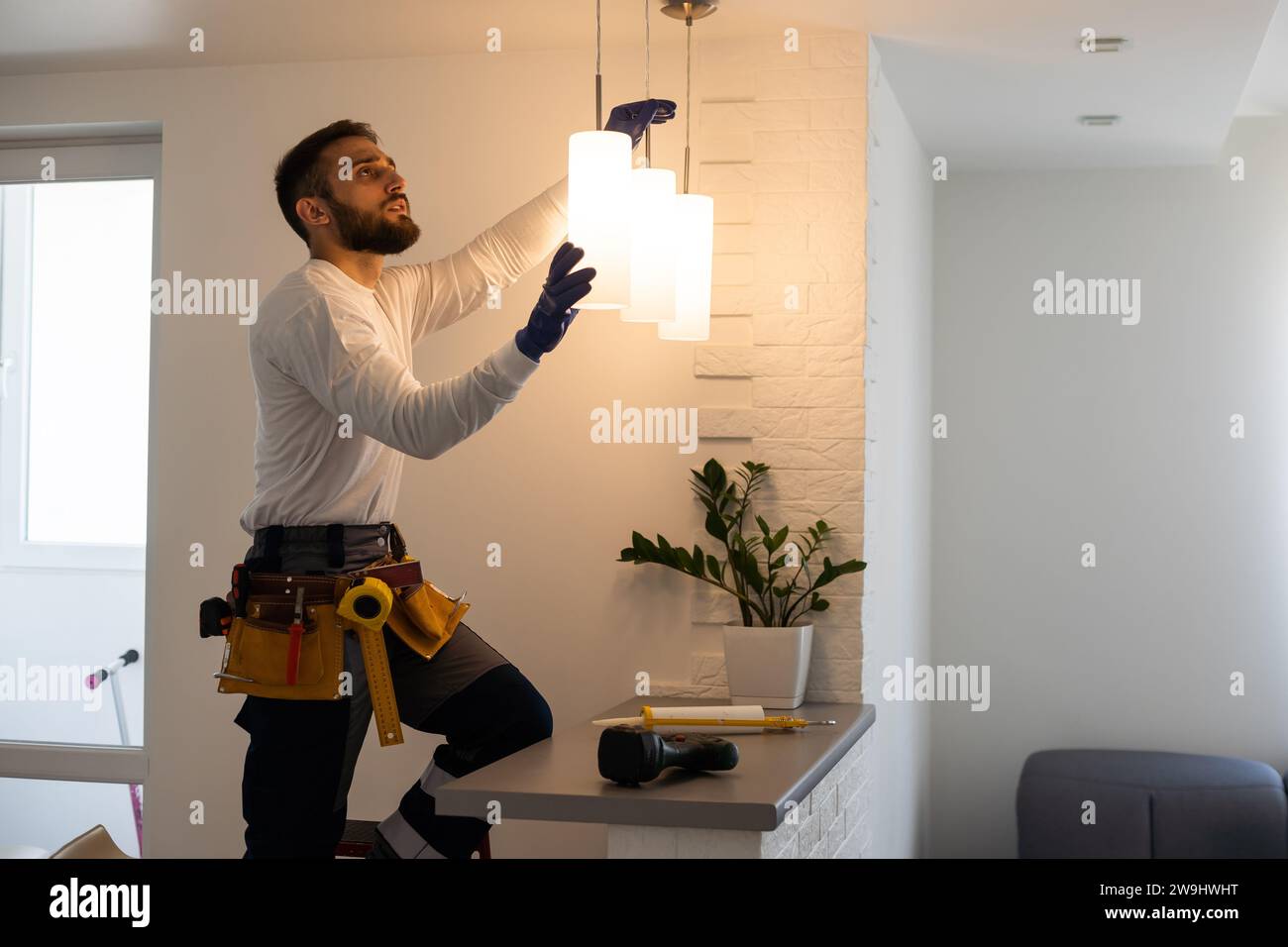 Electrician installs light on ceiling hi-res stock photography and ...