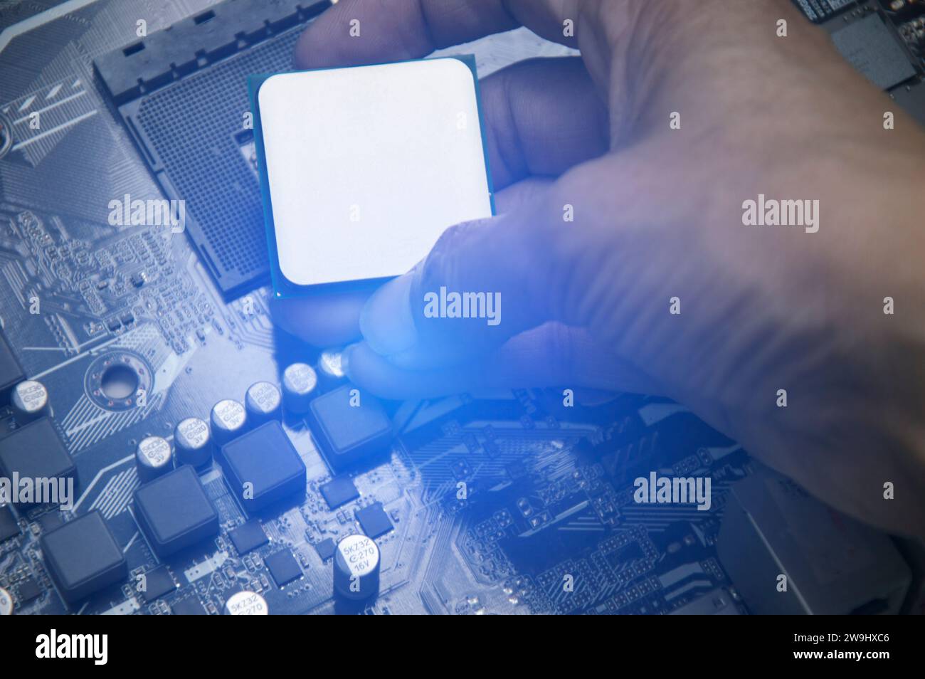 Top view of technician installing CPU chip on motherboard, CPU chip It's the brain part of the ...