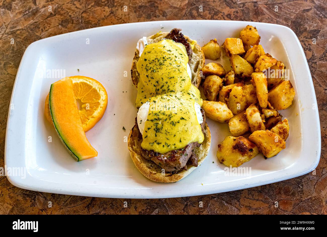 Eggs Benedict over a beef sirloin steak, high protein breakfast plate ...