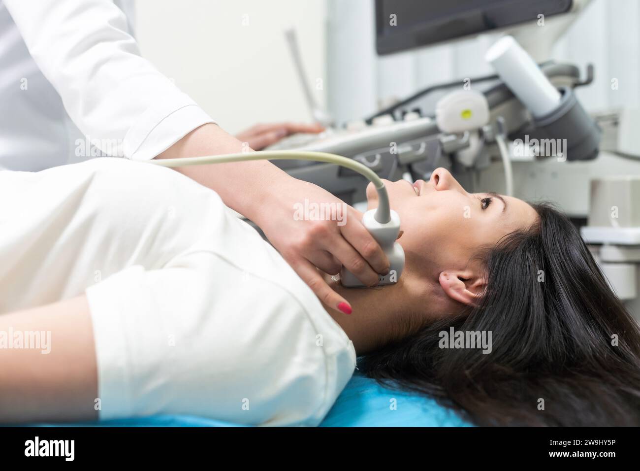 Ultrasound scanning diagnostic of woman thyroid gland in clinic, doctor ...