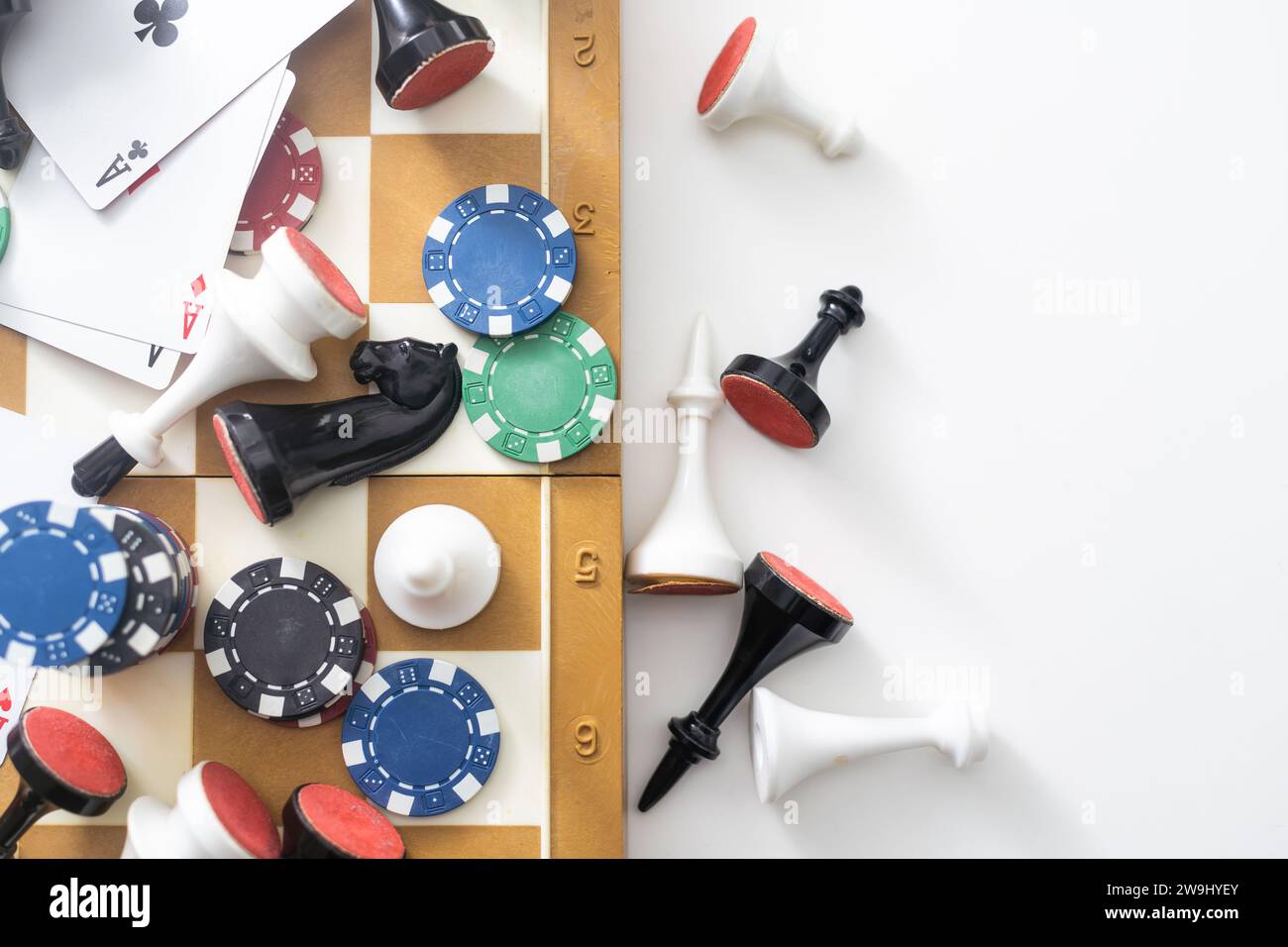 Wooden checkers, chess pieces, playing cards, board games on a light ...