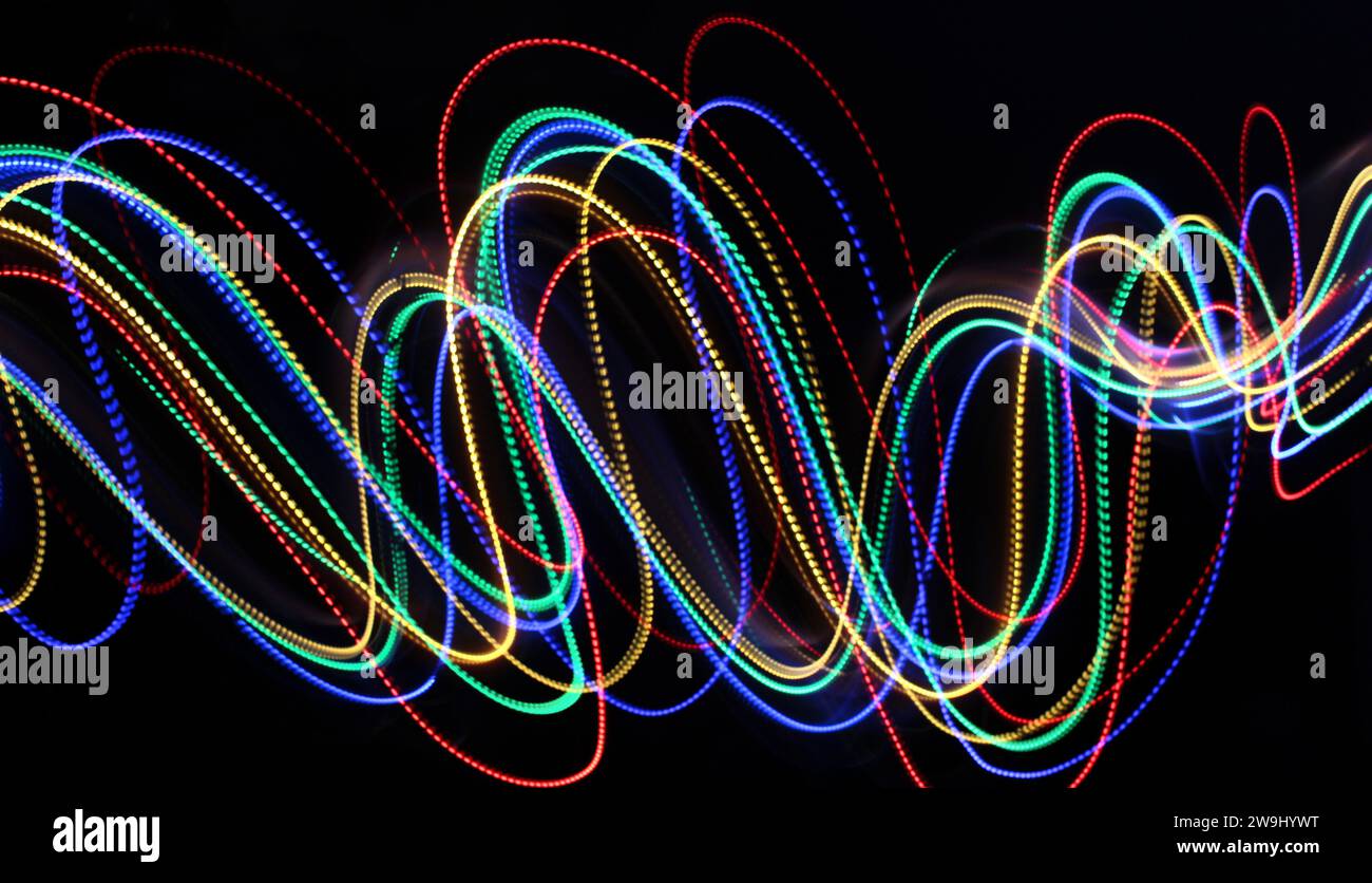 A photograph of vibrant multicolor dotted lines in a long exposure ...