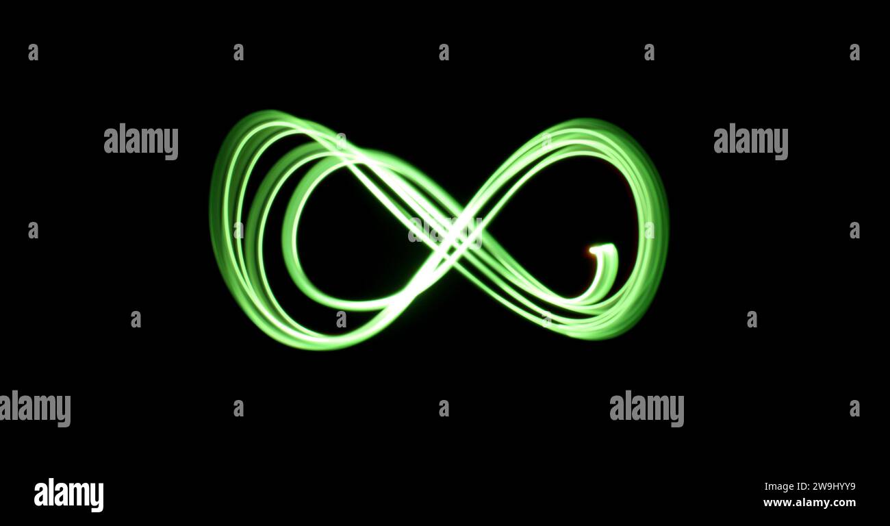 A photograph of an infinity loop symbol in vibrant green light in a ...