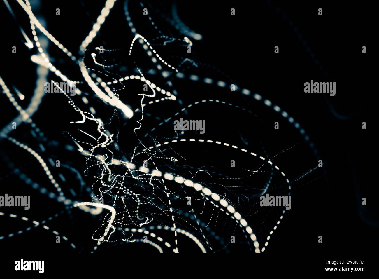 A photograph of vibrant white lights in a long exposure photo. Dotted ...