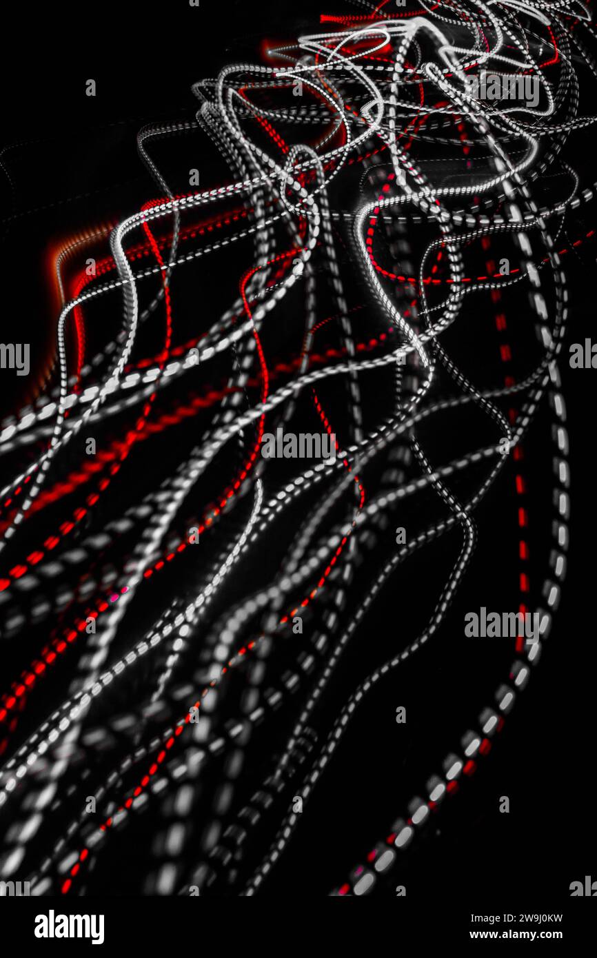 A photograph of vibrant red and white dotty lights in a long exposure ...