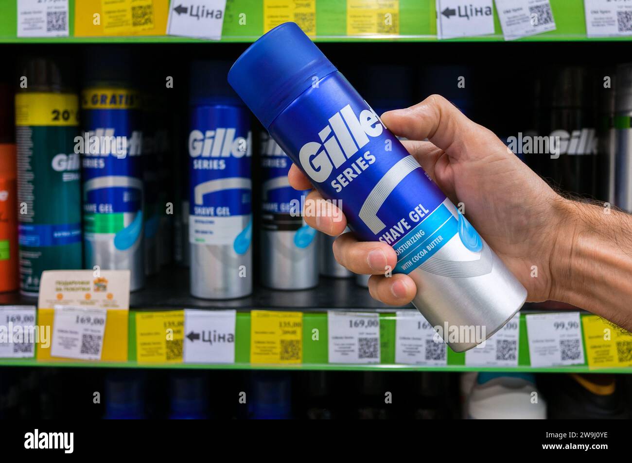 A man's hand holds a Gillette Series shaving gel against the background ...