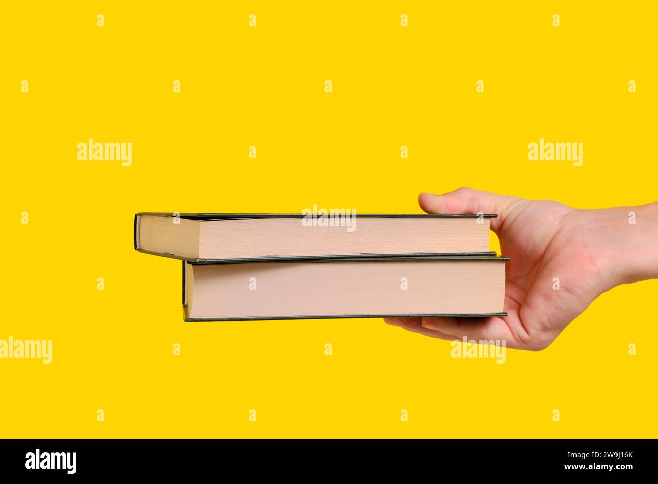 Books in hand yellow background. International book giving day Stock ...