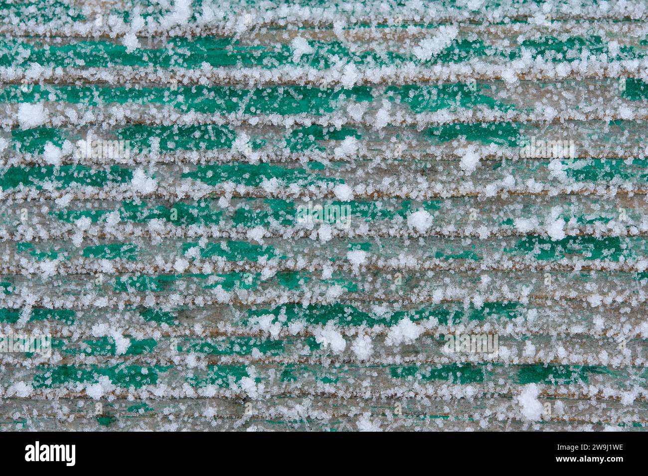 Old boards are covered with snow crystals and frost after severe frosts ...