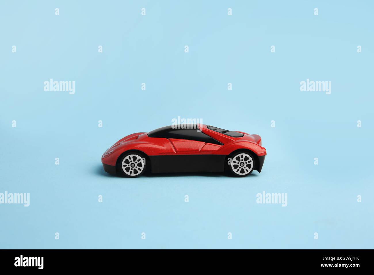One red car on light blue background. Children`s toy Stock Photo - Alamy