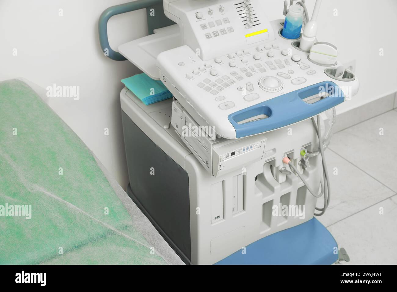 Ultrasound control panel and examination table in hospital, closeup ...