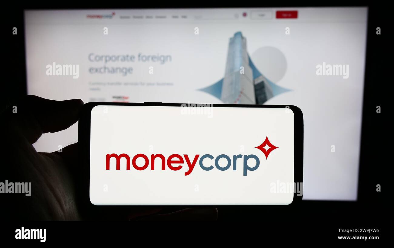 Person holding mobile phone with logo of British payments company TTT ...