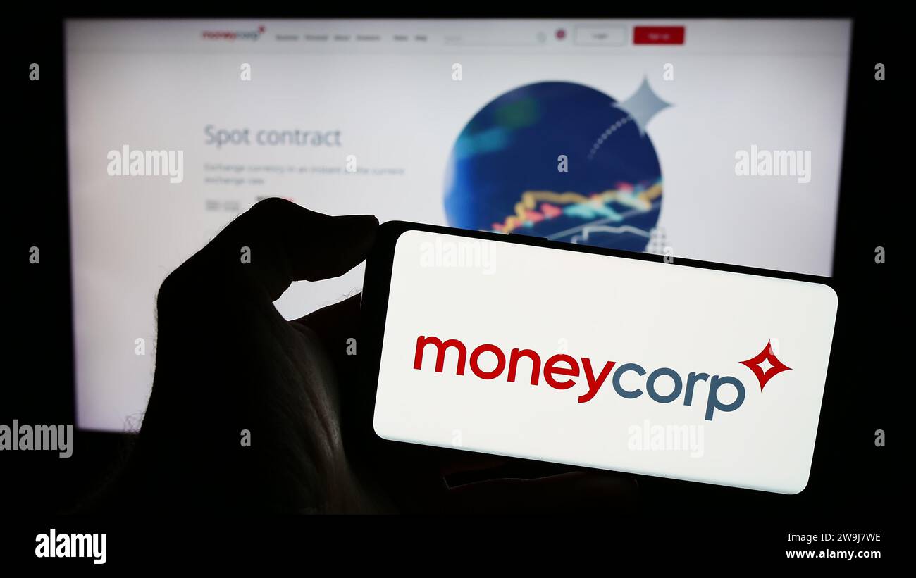 Person holding cellphone with logo of British payments company TTT ...