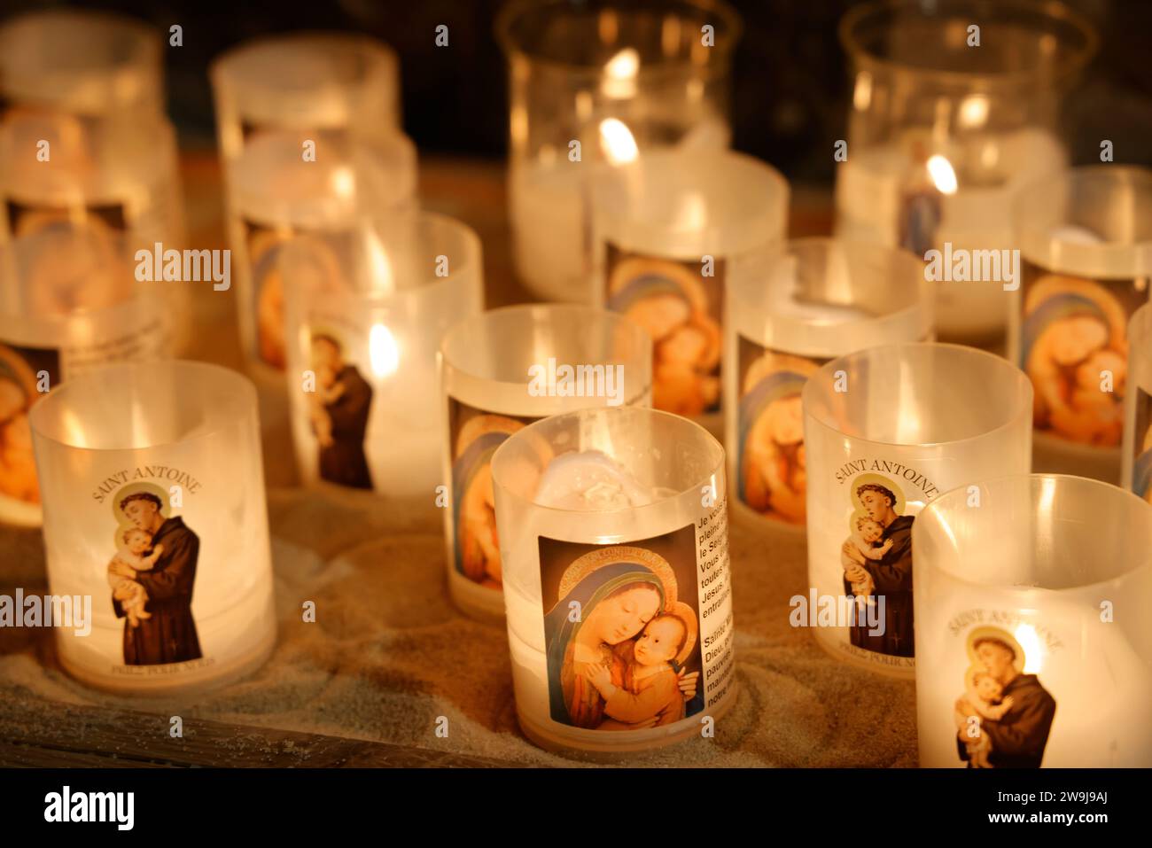 Prayer candles bearing the image of Mary, baby Jesus and Saint-Antoine ...