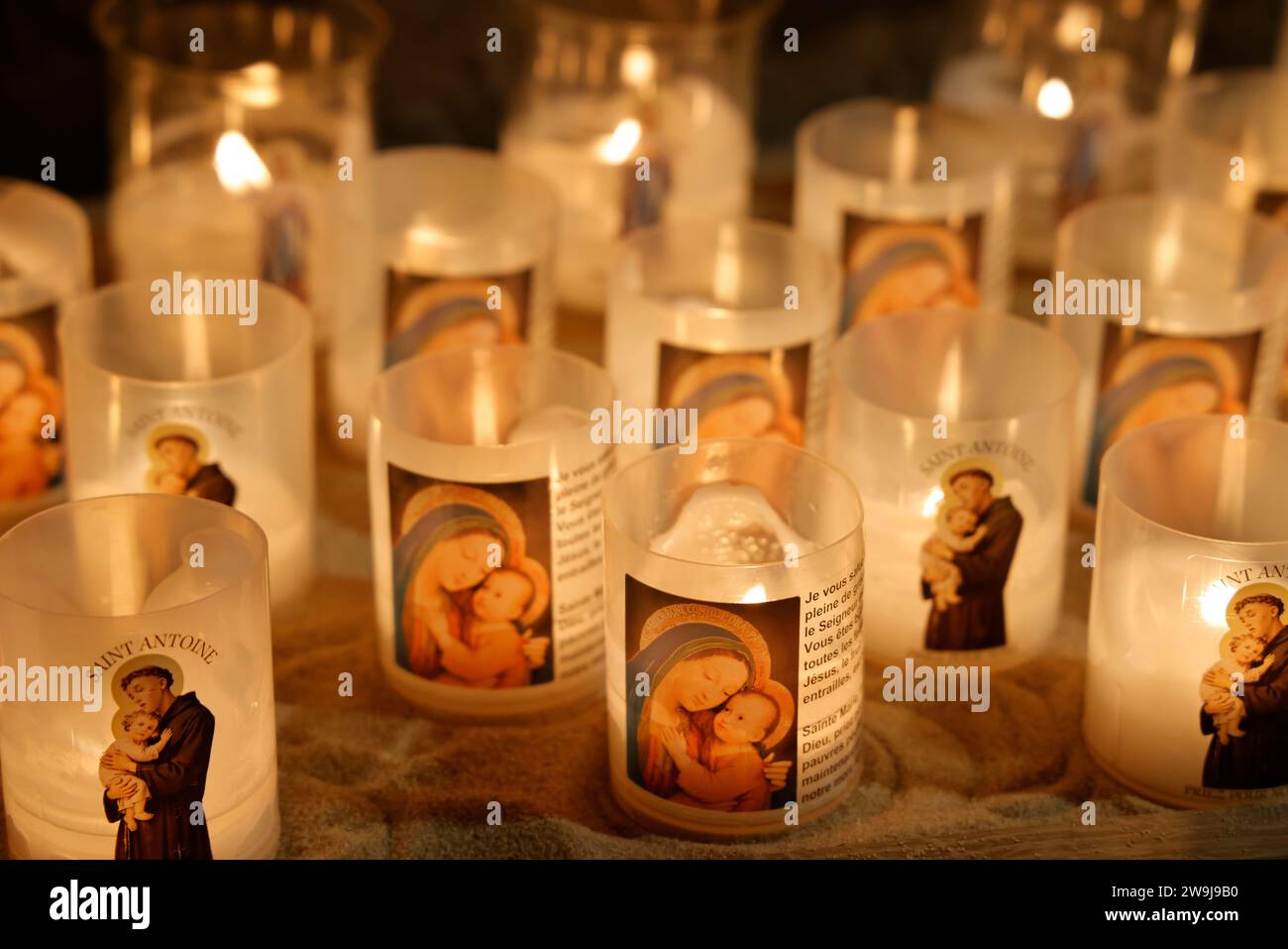 Prayer candles bearing the image of Mary, baby Jesus and Saint-Antoine ...