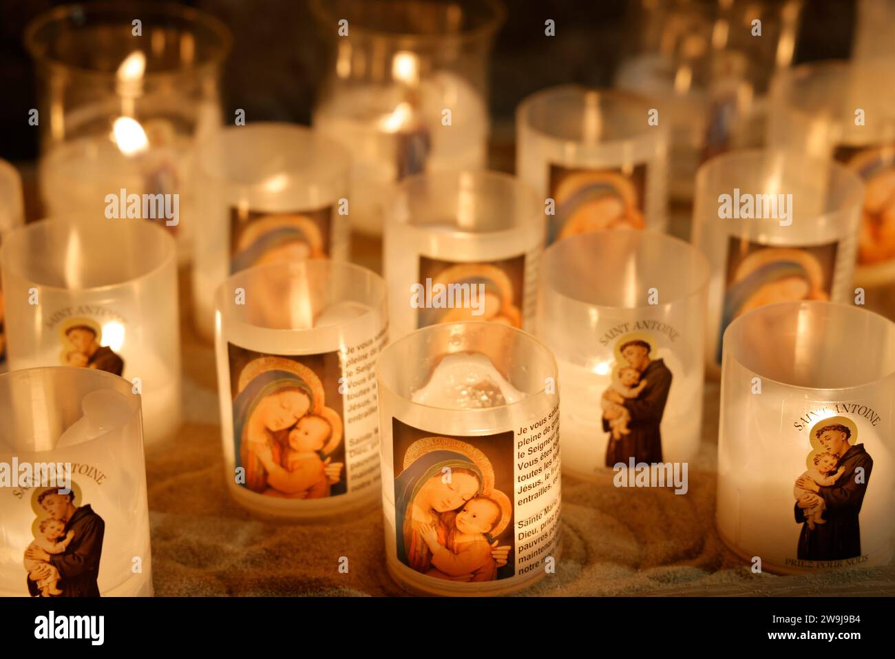 Prayer candles bearing the image of Mary, baby Jesus and Saint-Antoine ...