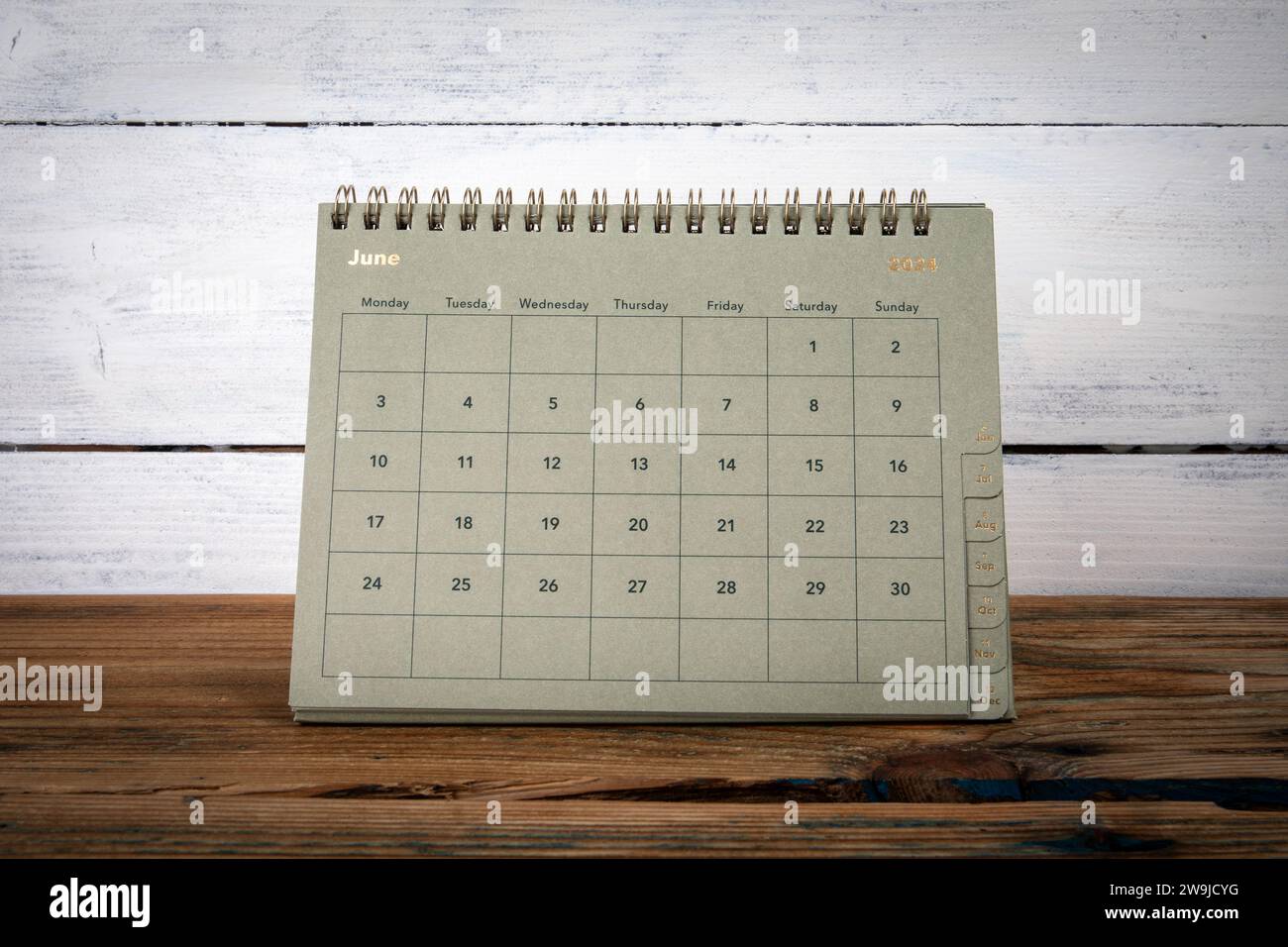 JUNE 2024 cardboard desk calendar and planner on a wooden texture table ...
