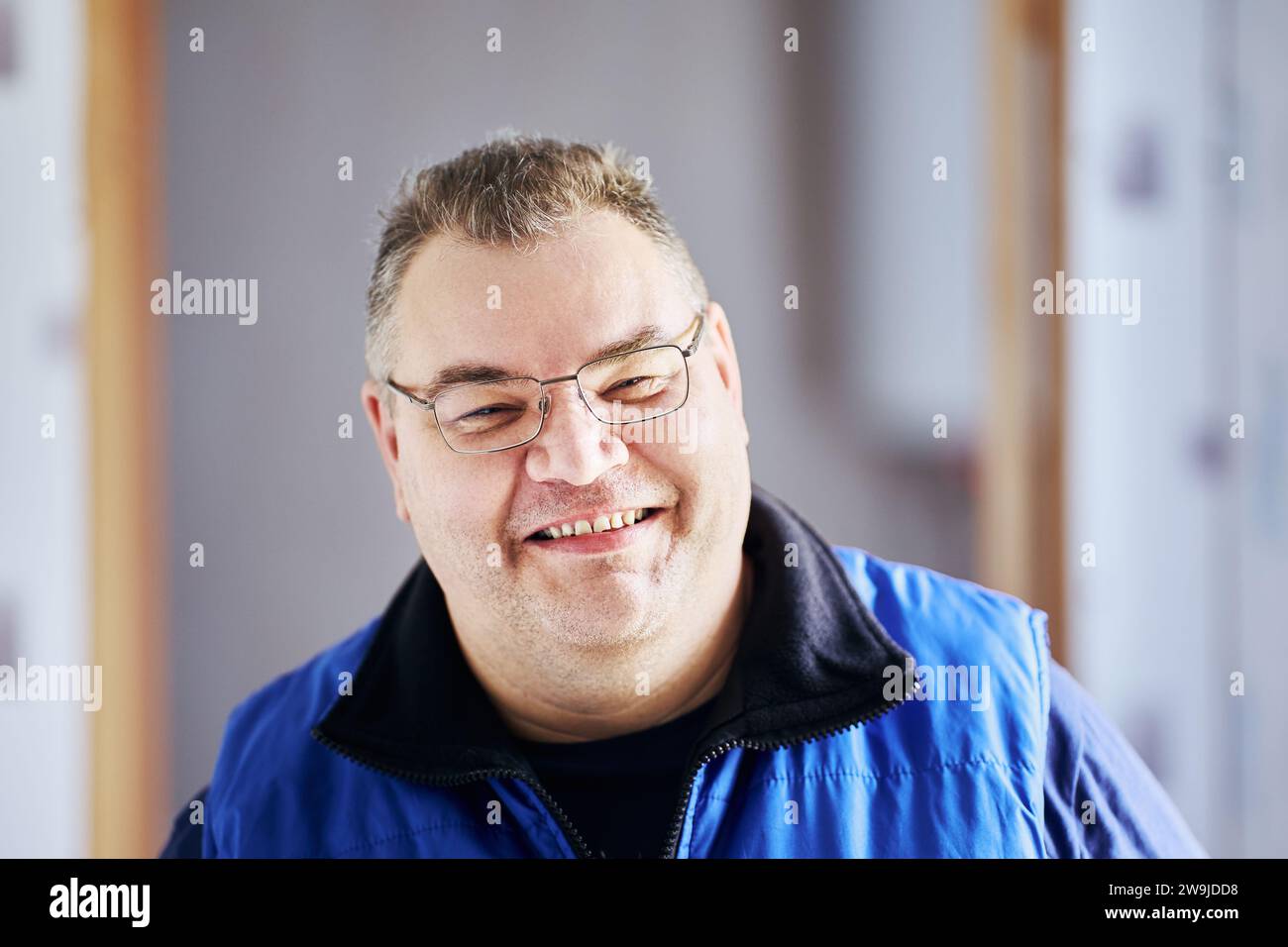 Large build man smiles cheekily, his face in glasses close-up Stock ...