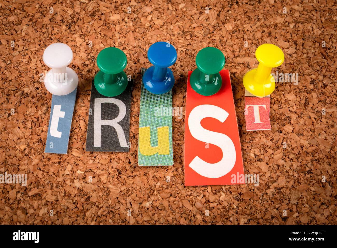 TRUST Concept. Letters pinned to a cork notice board Stock Photo - Alamy
