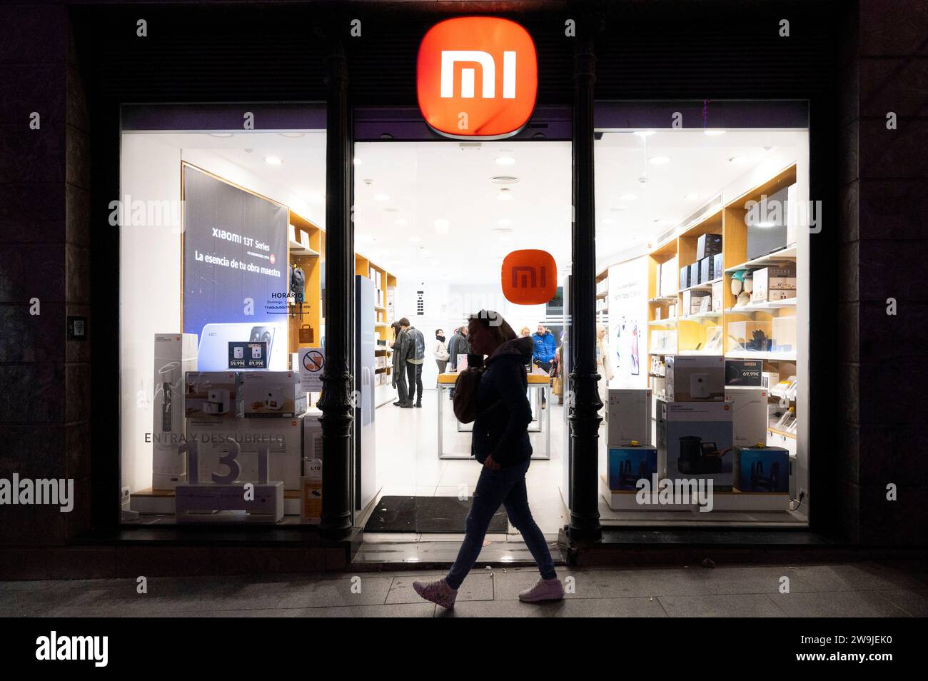 A pedestrian walks past the Chinese multinational technology and ...