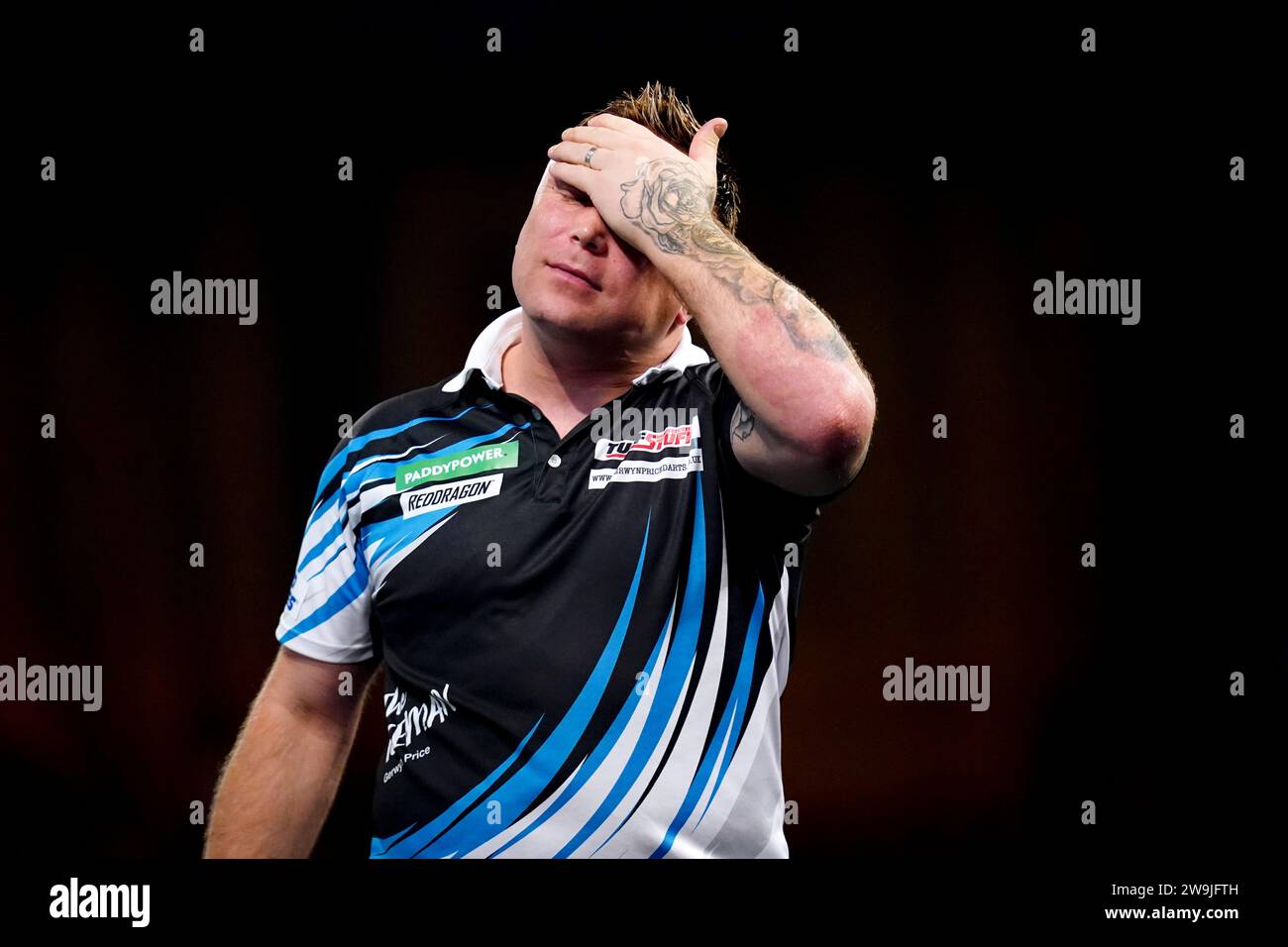 Gerwyn Price walks off dejected after losing to Brendan Dolan on day ...