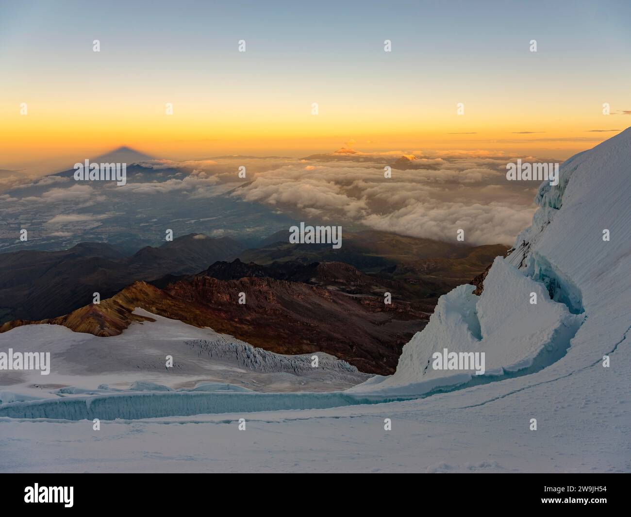 View from the glacier of the Cayambe volcano to its shadow at sunrise ...