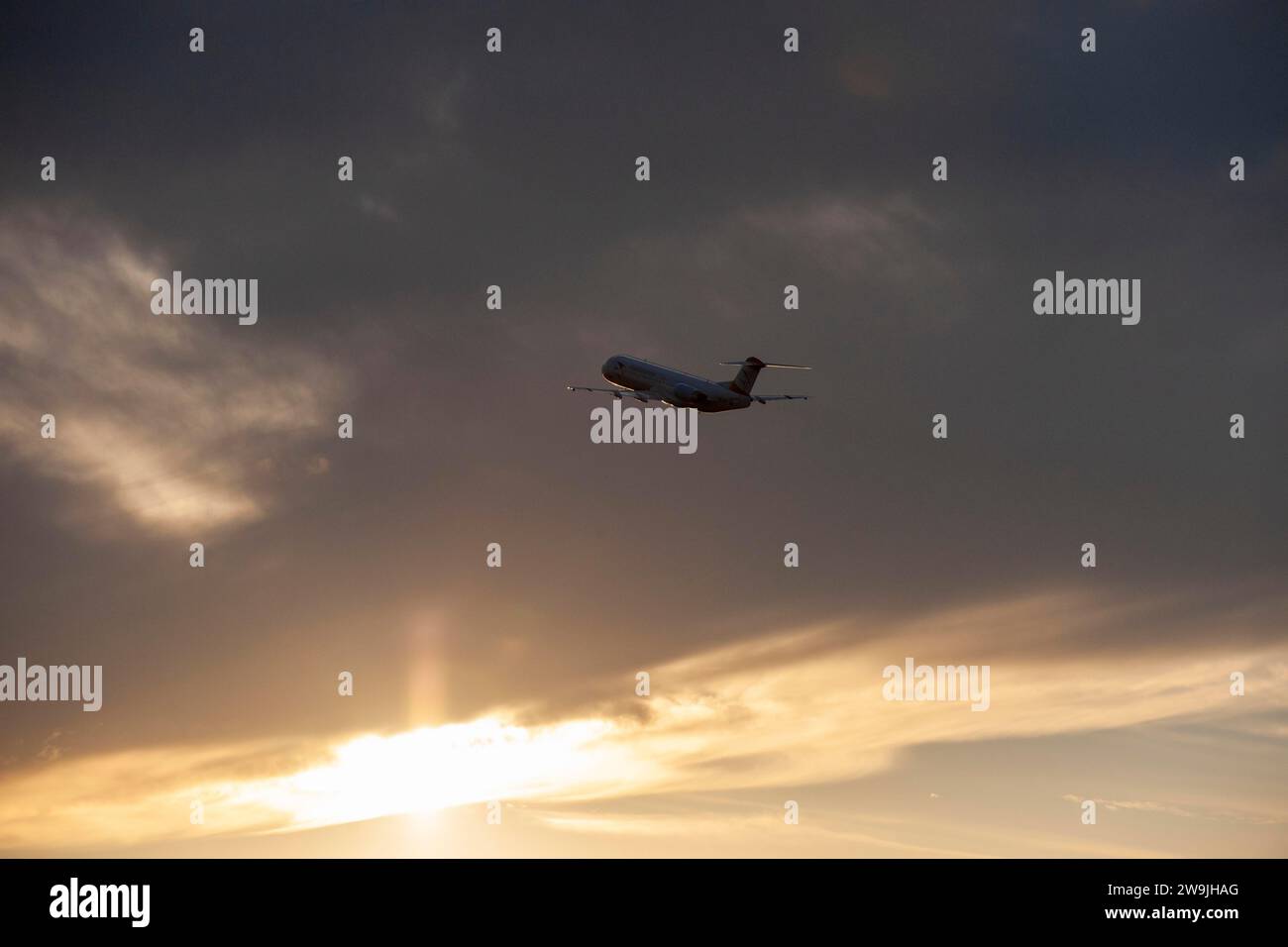 Passenger plane taking off in front of evening sky, sunset, Germany ...