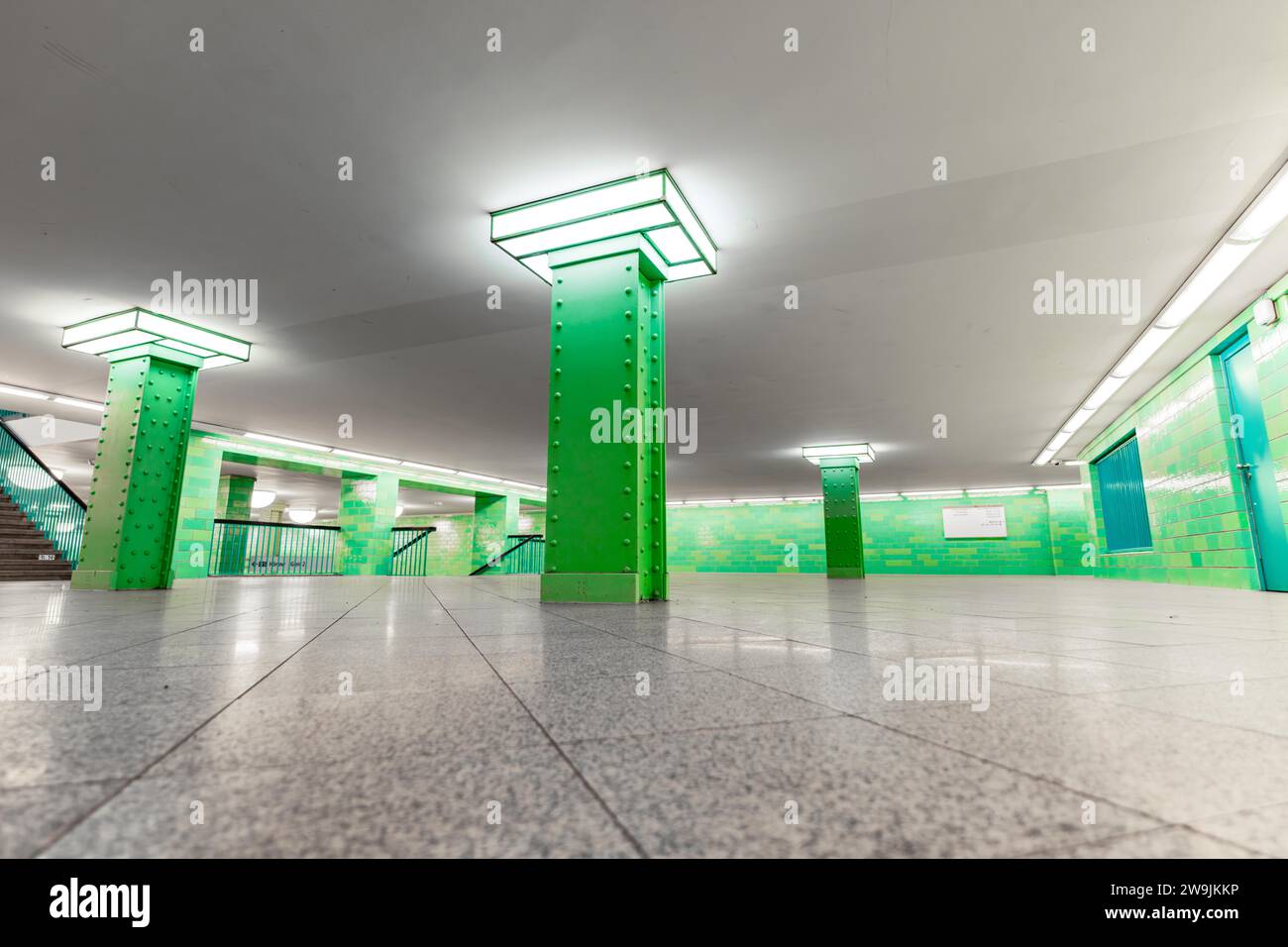 Symmetrically arranged green columns in a modern underground station ...