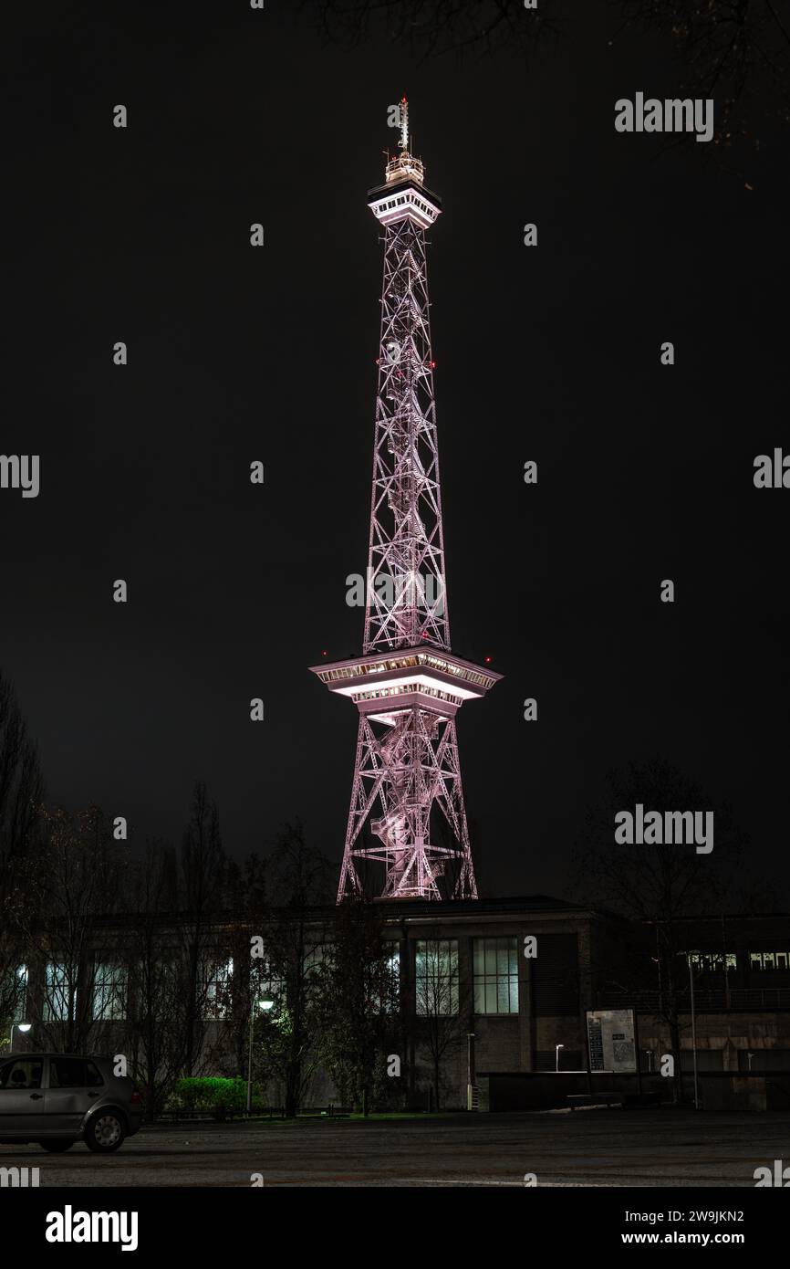 Tower illuminated at night, rises up into the dark sky, Radio Tower ...