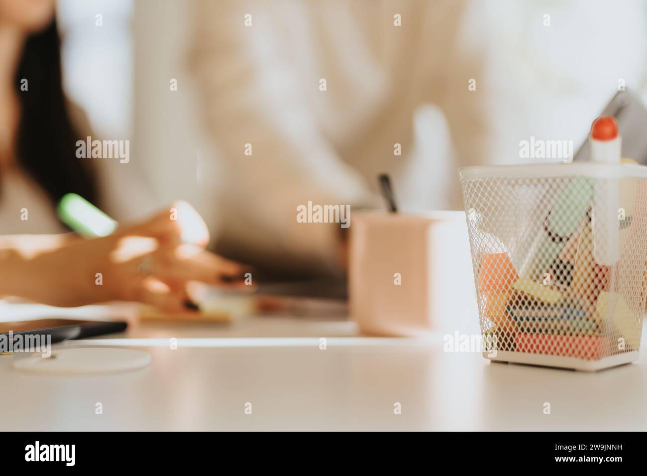 Successful collaboration in a sunlit office with a multi-generational ...