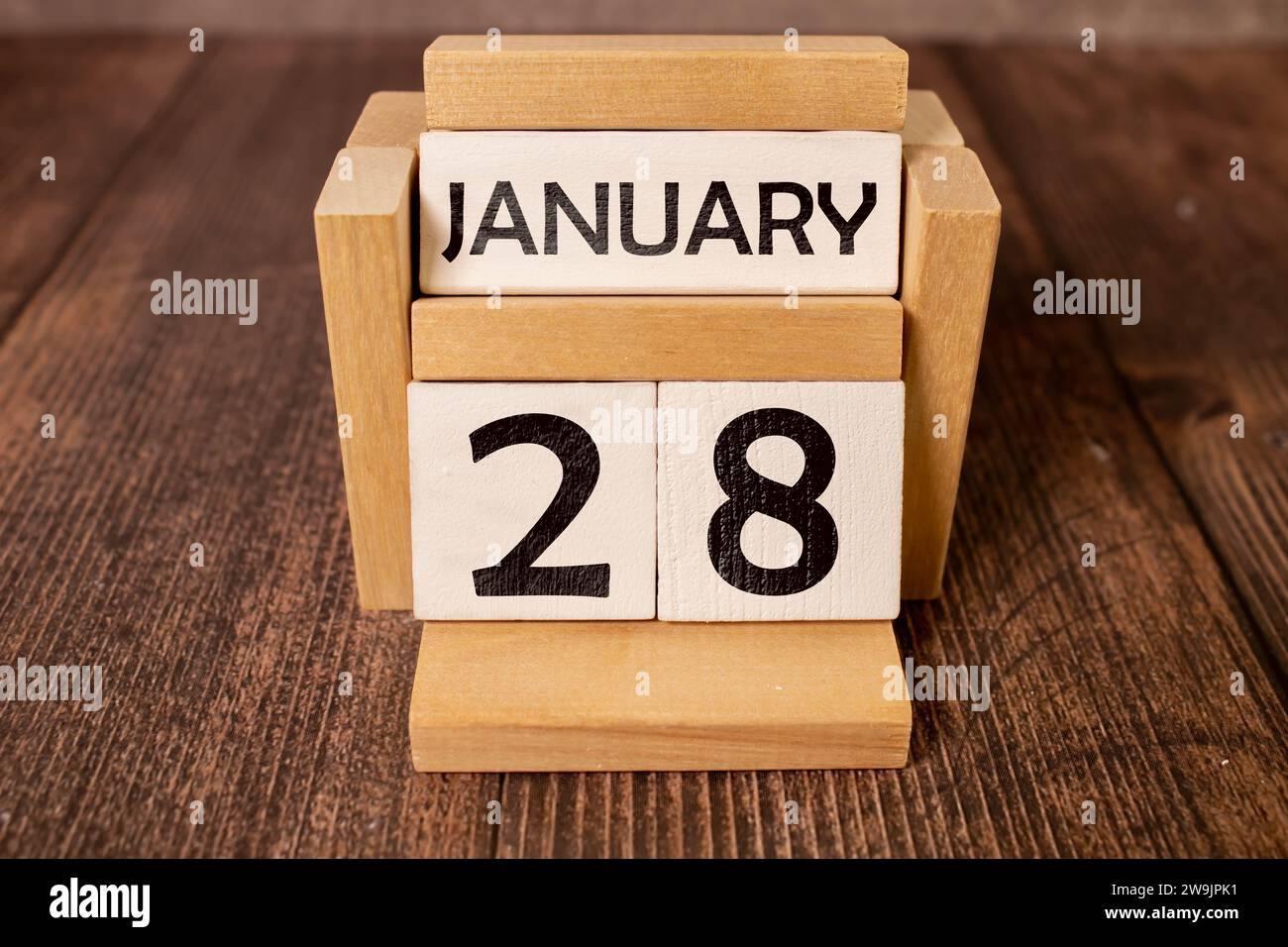 Wooden calendar, a set of dates of the month 28 January, on a white and ...
